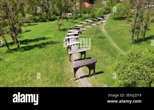 Aerial drone view of wooden arched pergolas along a cobblestone walkway ...