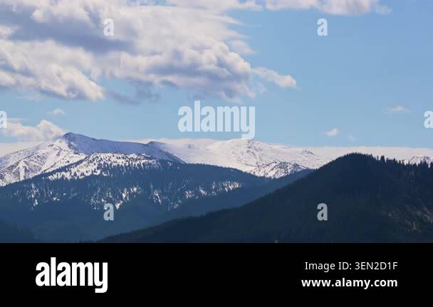 Aerial drone view of snow covered peaks in the Carpathians, with ...