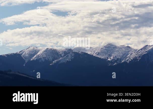 Aerial drone view of snow covered mountain peaks under soft light, part ...