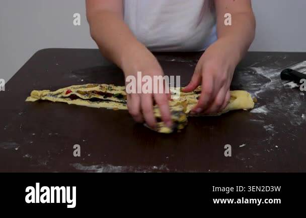 series of baking videos shows a woman rolling soft yeast dough filled ...