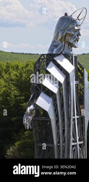 Aerial drone view of a steel Christ figure head and halo against green ...