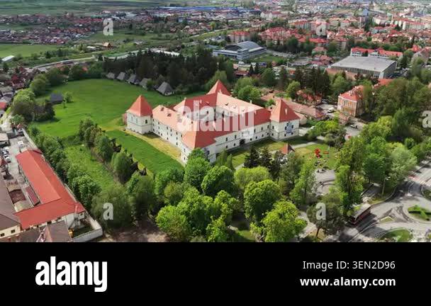 High-altitude aerial view of a white castle, a town and an Orthodox ...
