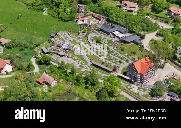 Overhead aerial view of a heritage park with stone paths and wooden ...