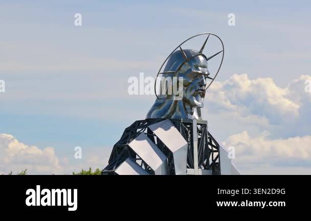 Aerial drone view of a steel Christ figure with halo in three-quarter ...