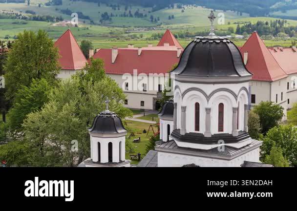 Aerial drone view of an Orthodox church with black domes beside a ...