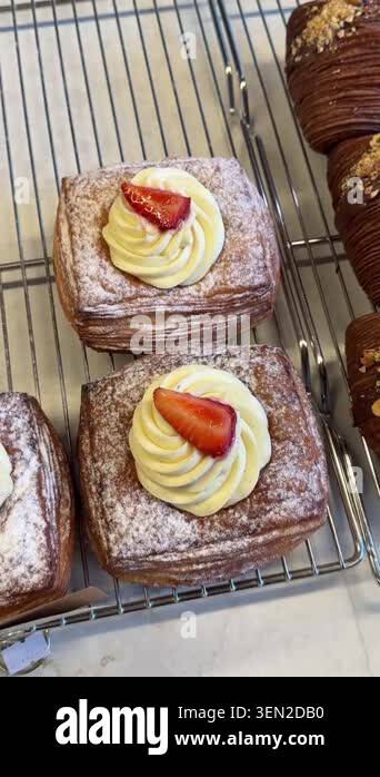 Two delicate puff pastry treats filled with smooth cream and topped ...