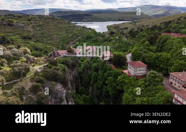 Aerial panoramic shot approaching an iron bridge over a deep rocky ...