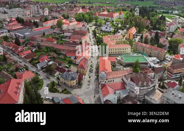 Aerial drone view of a historic city center with red roofs, a castle ...
