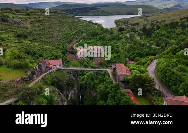 Aerial panoramic view of a metal bridge and historic stone church over ...