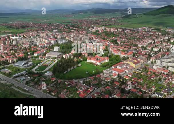 Aerial drone view of a Transylvanian city with red roofs and a ...