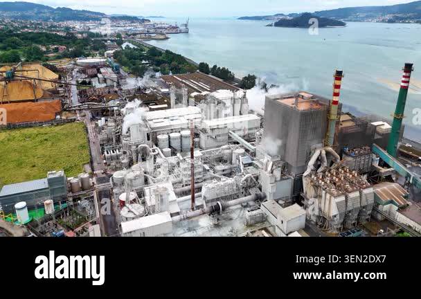 Industrial pulp and paper factory on the coastline, with smokestacks ...