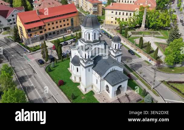Aerial drone view of a white Orthodox church with dark domes in a city ...