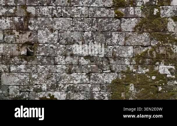 Camera slowly moving backward revealing the ancient, roofless stone ...