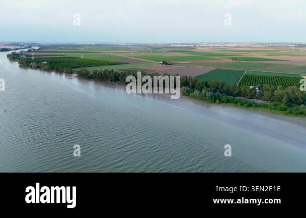 Aerial view flying over the Guadalquivir river, showcasing the vast ...