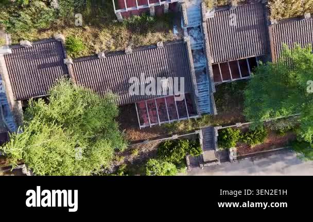 Aerial view moving away from an old, abandoned tourist village with ...