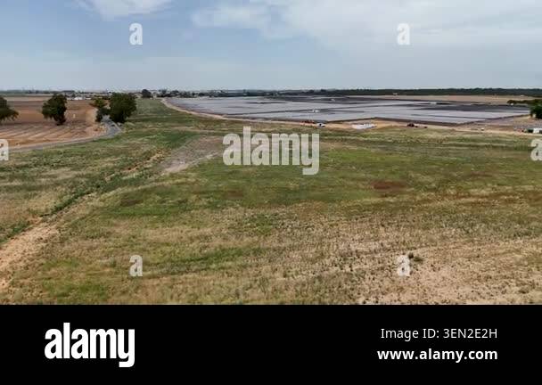 Drone footage flying over a large scale solar panel farm under ...