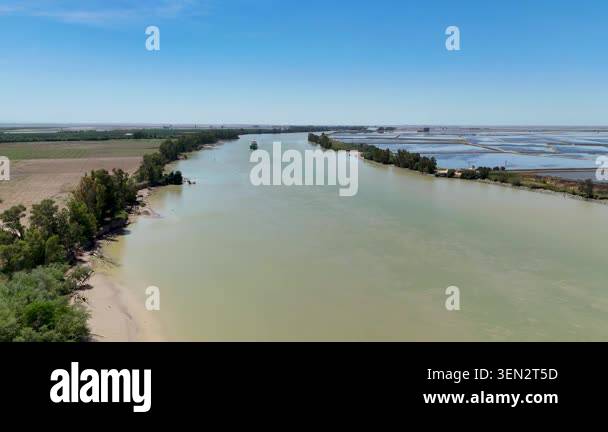 Aerial view of a cargo ship navigating the Guadalquivir river ...