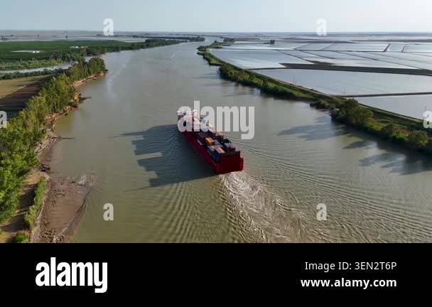 Large container ship transporting goods sailing on the Guadalquivir ...