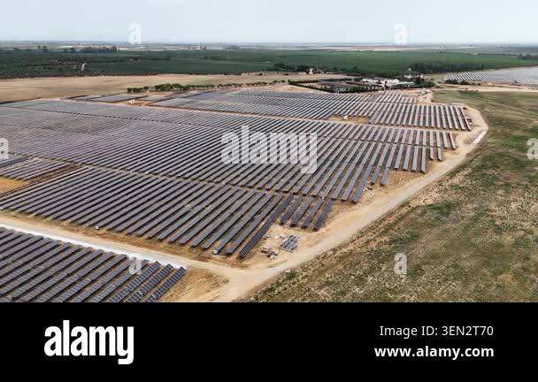 Vast solar farm with rows of photovoltaic panels generating clean ...