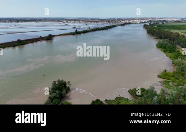 Beautiful aerial view of the muddy waters of the Guadalquivir river ...