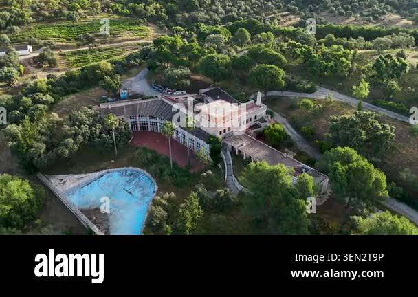 Aerial view of a desolate, ruined building and its dry, derelict ...