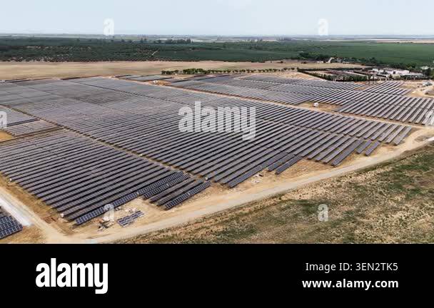 Huge solar farm with rows of photovoltaic panels generating renewable ...