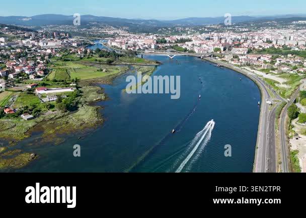 Aerial drone view of speed boat cruising towards Pontevedra city in ...
