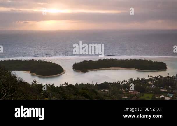 Sunrise over turquoise lagoon Muri, small islands and village, pastel ...