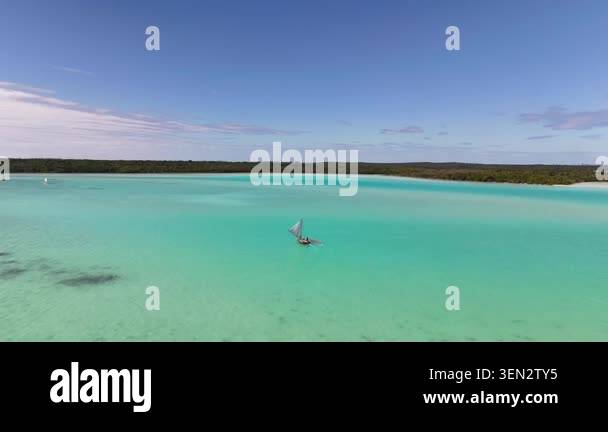 Aerial turquoise lagoon with a boat in the shallow crystal water near ...
