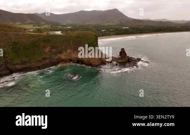 Rugged coastal cliffs and turquoise sea, aerial drone survey captures ...
