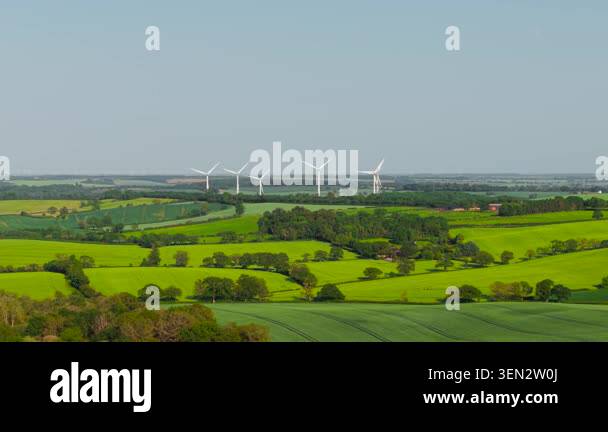 Wind turbines generating clean electricity over green countryside ...