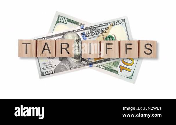 100 US dollar note on a USA flag with wooden cubes and word TARIFFS ...