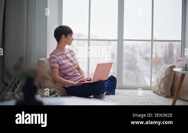 Smiling lady chatting laptop enjoying online communication sitting ...