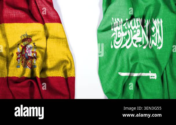 waving national colorful flag of spain and national flag of saudi ...