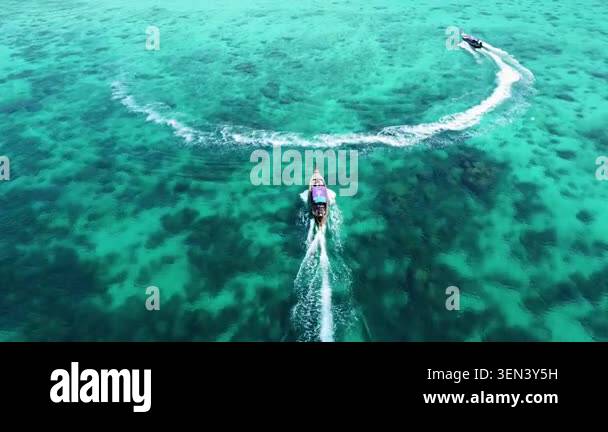 Stunning aerial footage of a traditional long tail boat cruising ...
