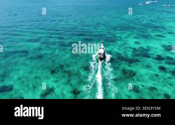 Aerial view of a traditional thai long tail boat sailing across the ...