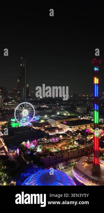 Aerial view of a colorful amusement park with a ferris wheel and other ...