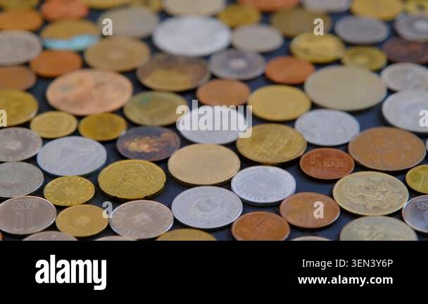 A collection of various coins, including some with symbols and designs ...