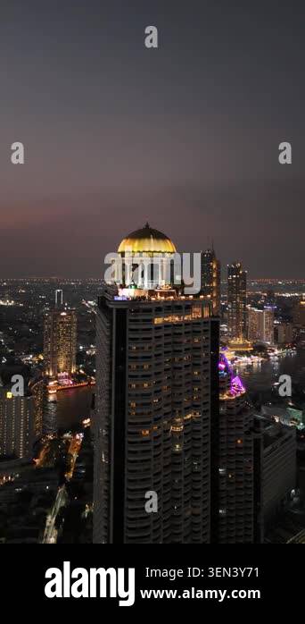Aerial view of a modern skyscraper featuring a luxurious golden dome ...