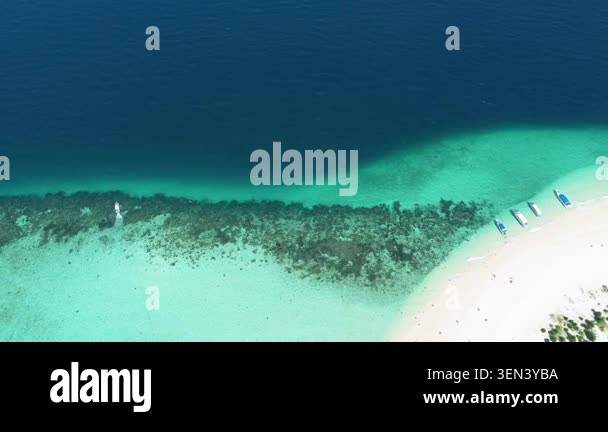 Aerial view of a tropical island with a white sand beach, turquoise ...