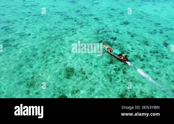 Aerial view of a traditional long tail boat sailing across the ...
