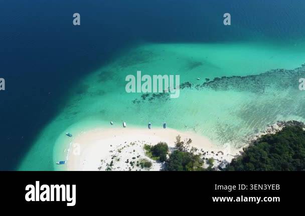 Aerial view of a tropical island with a white sand beach, turquoise ...