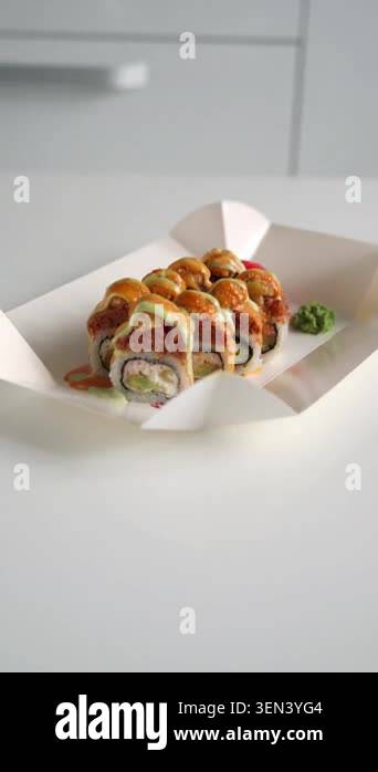 Close-up of a fresh sushi set in a takeaway box. Delicious Japanese ...