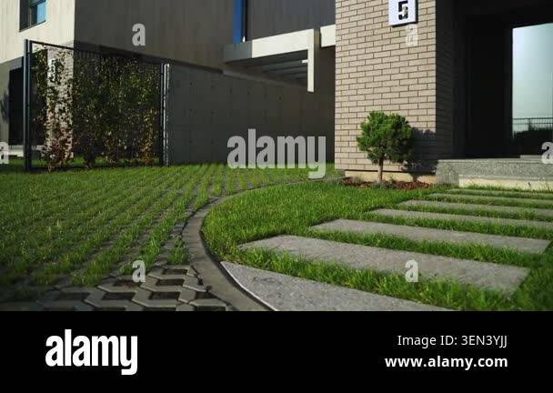 Moving shadows slowly gliding across the pristine landscaped lawn and ...