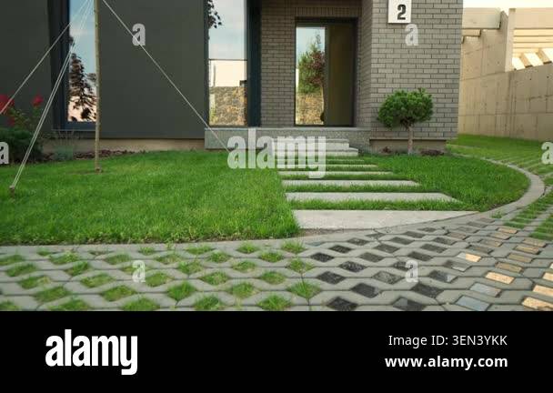 Modern home exterior featuring an innovative permeable paving system ...