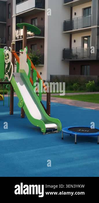 Modern and colorful childrens playground situated in the courtyard of a ...