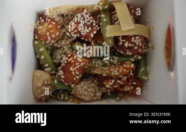 Delicious Asian cuisine in a takeaway box. Stir-fried chicken, noodles ...