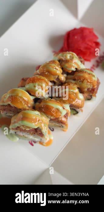 Japanese food delivery concept. Tasty baked uramaki rolls with wasabi ...