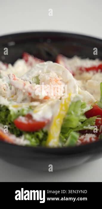 Close-up shot of a person eating a delicious shrimp salad with lettuce ...