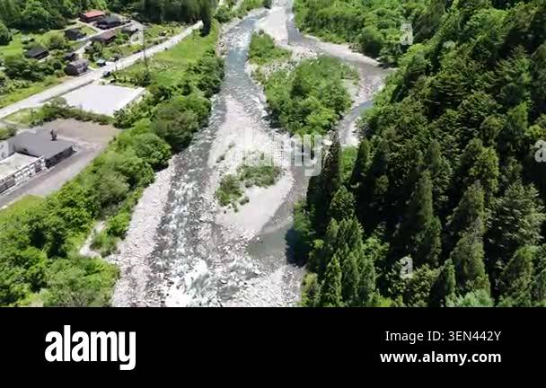 Aerial view of winding river surrounded by greenery Stock Video Footage ...